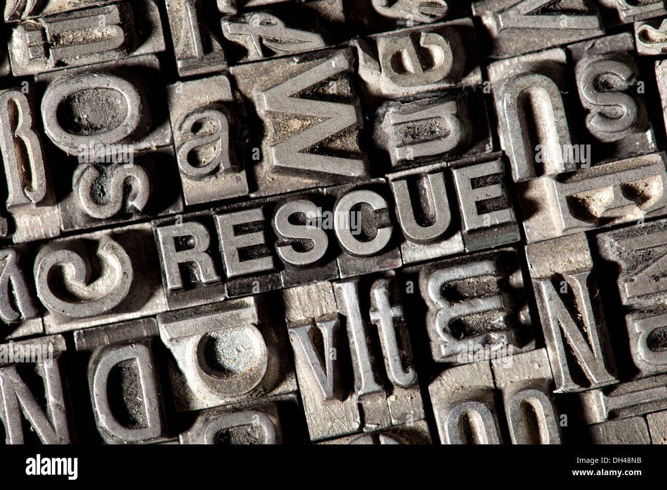 Old lead letters forming the word RESCUE Stock Photo - Alamy