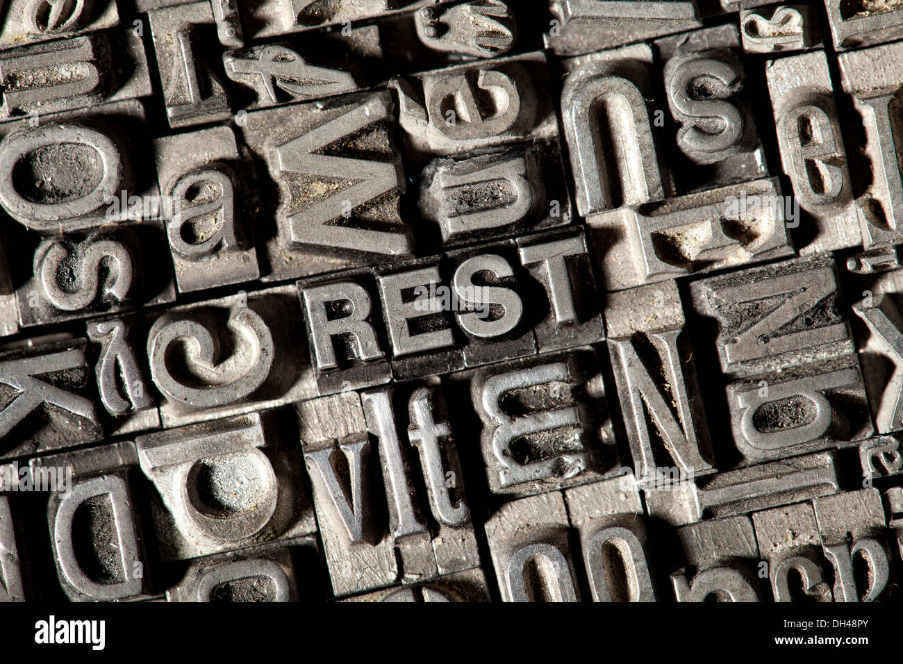 Old lead letters forming the word REST Stock Photo - Alamy
