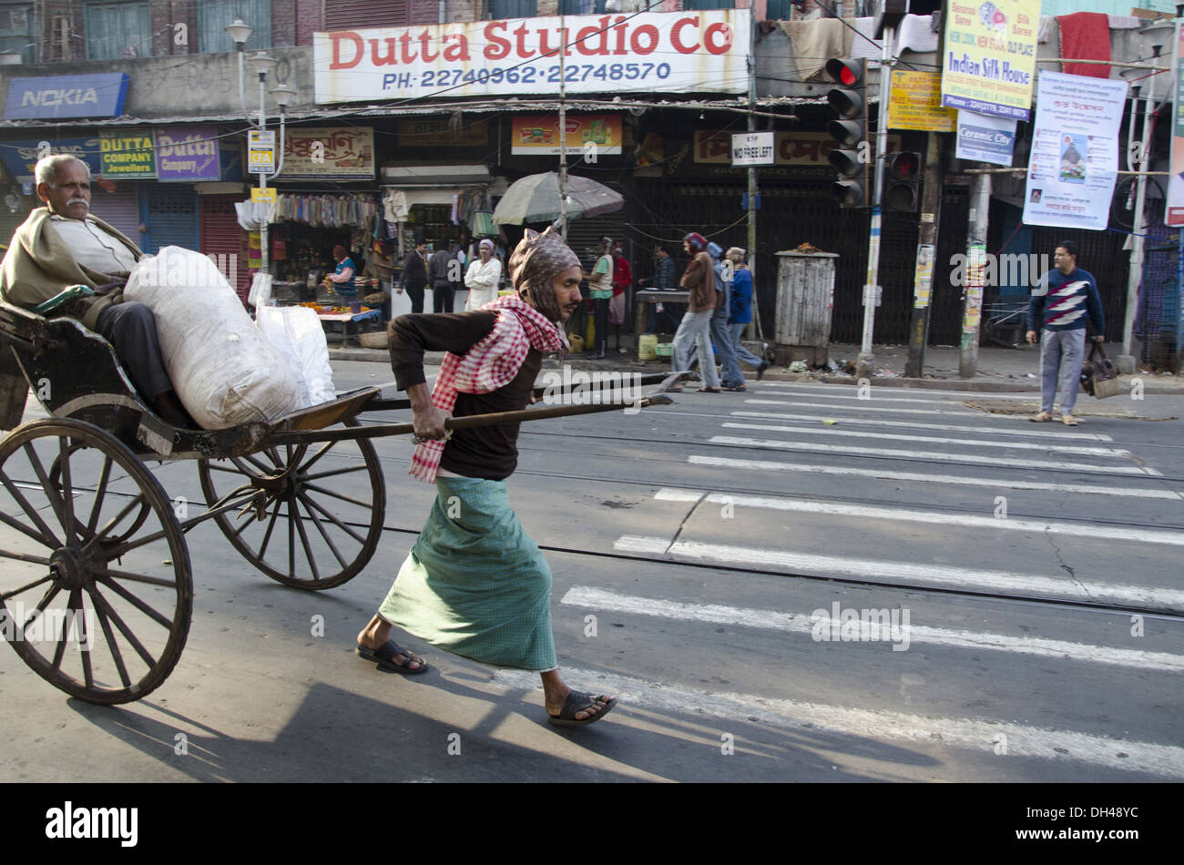 indian pulling hand rickshaw puller with man passenger and luggage at ...