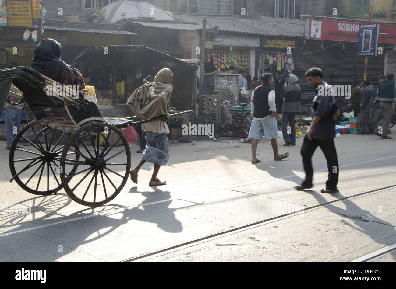 Indian man pulling rickshaw passenger hi-res stock photography and ...