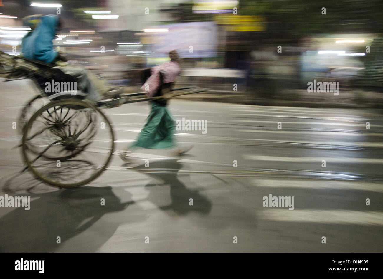 Indian man pulling rickshaw passenger hi-res stock photography and ...