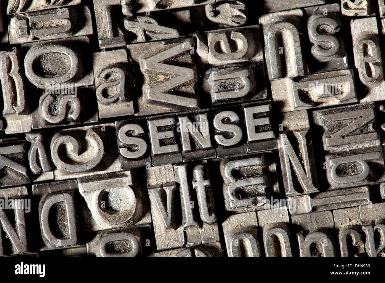 Old lead letters forming the word SENSE Stock Photo - Alamy