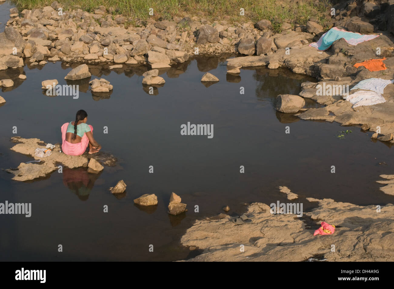 Lady on rock washing clothes Bhandardara Maharashtra India Asia Feb ...