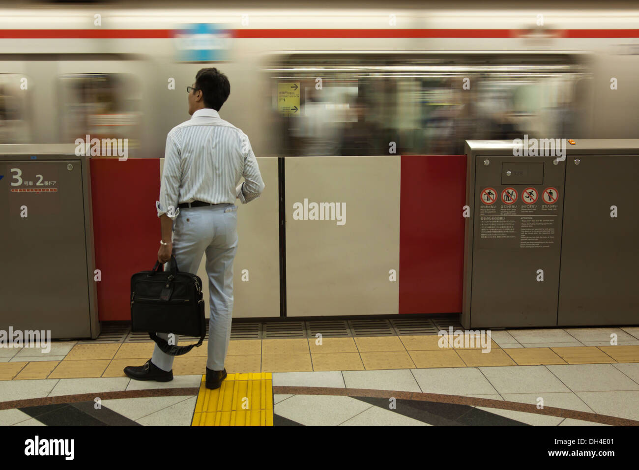 Man on metro subway underground station - Tokyo Stock Photo - Alamy