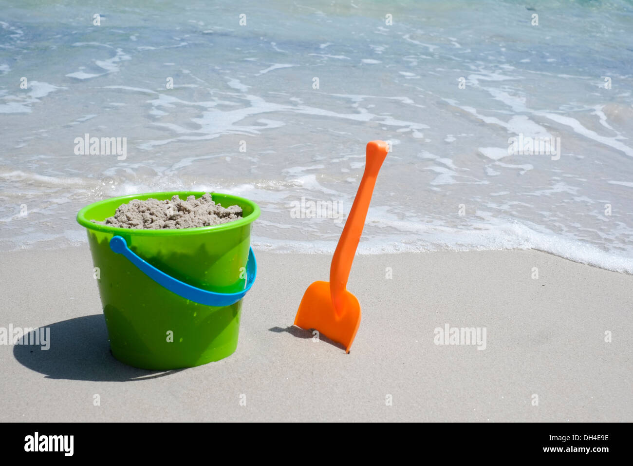 Bucket and shovel on a sandy beach Stock Photo - Alamy