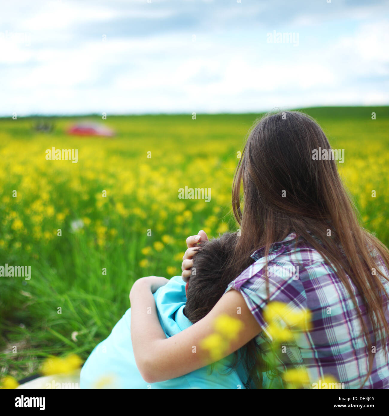 lovers hug on yellow flower field Stock Photo - Alamy