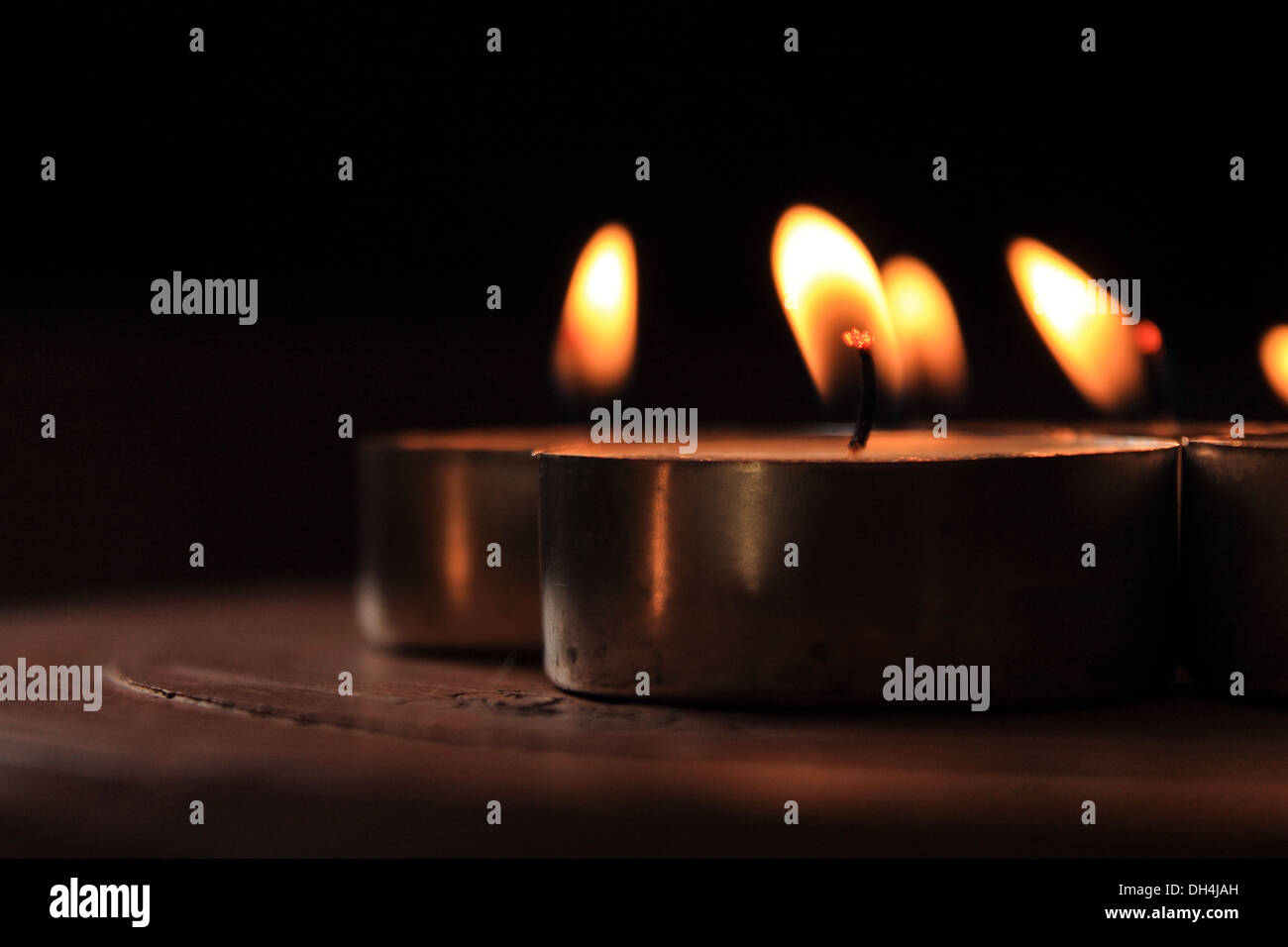 Candles alight and arranged Stock Photo - Alamy