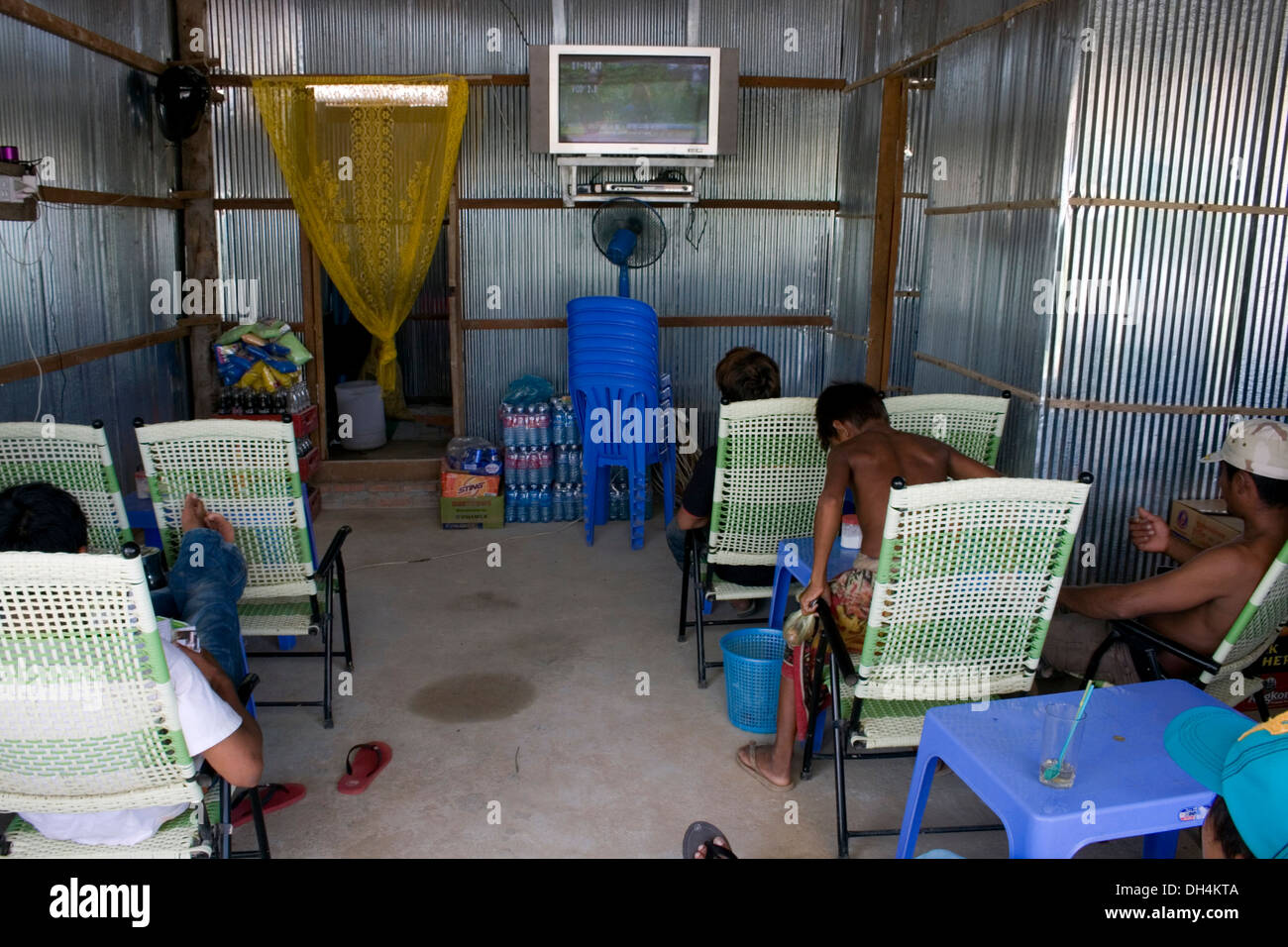 Men & boys who work in the recycling industry are relaxing & watching a ...