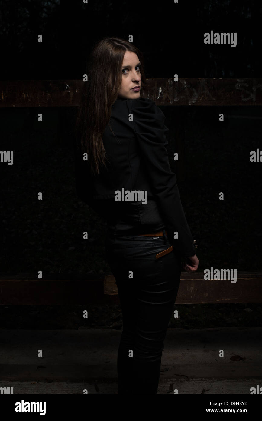 young woman looking behind her shoulder Stock Photo - Alamy