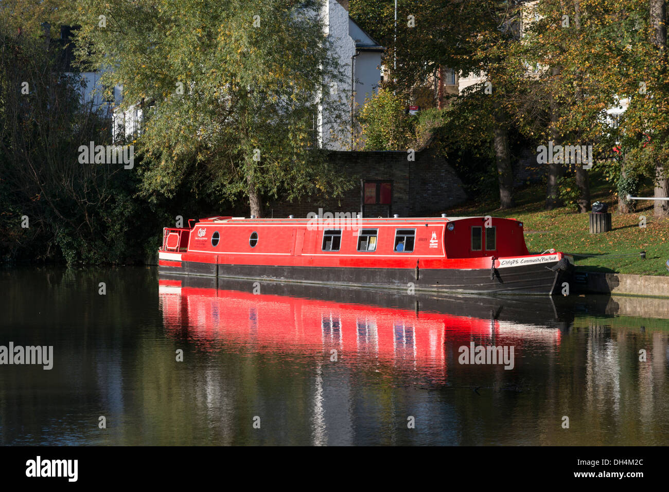 A red longboat or narrowboat moored on the River Cam Cambridge UK Stock ...