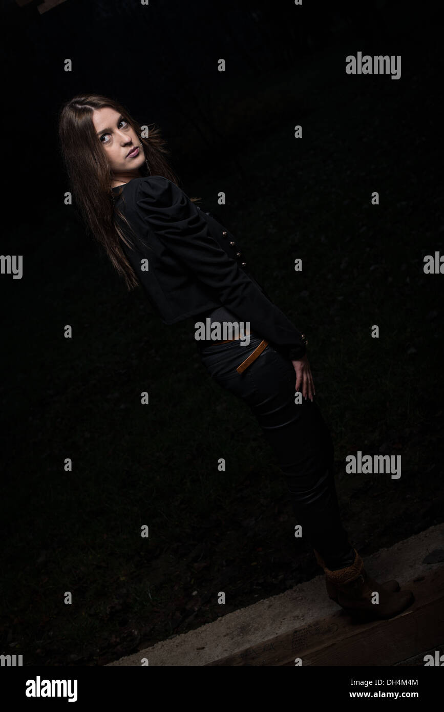 young woman looking behind her shoulder Stock Photo - Alamy