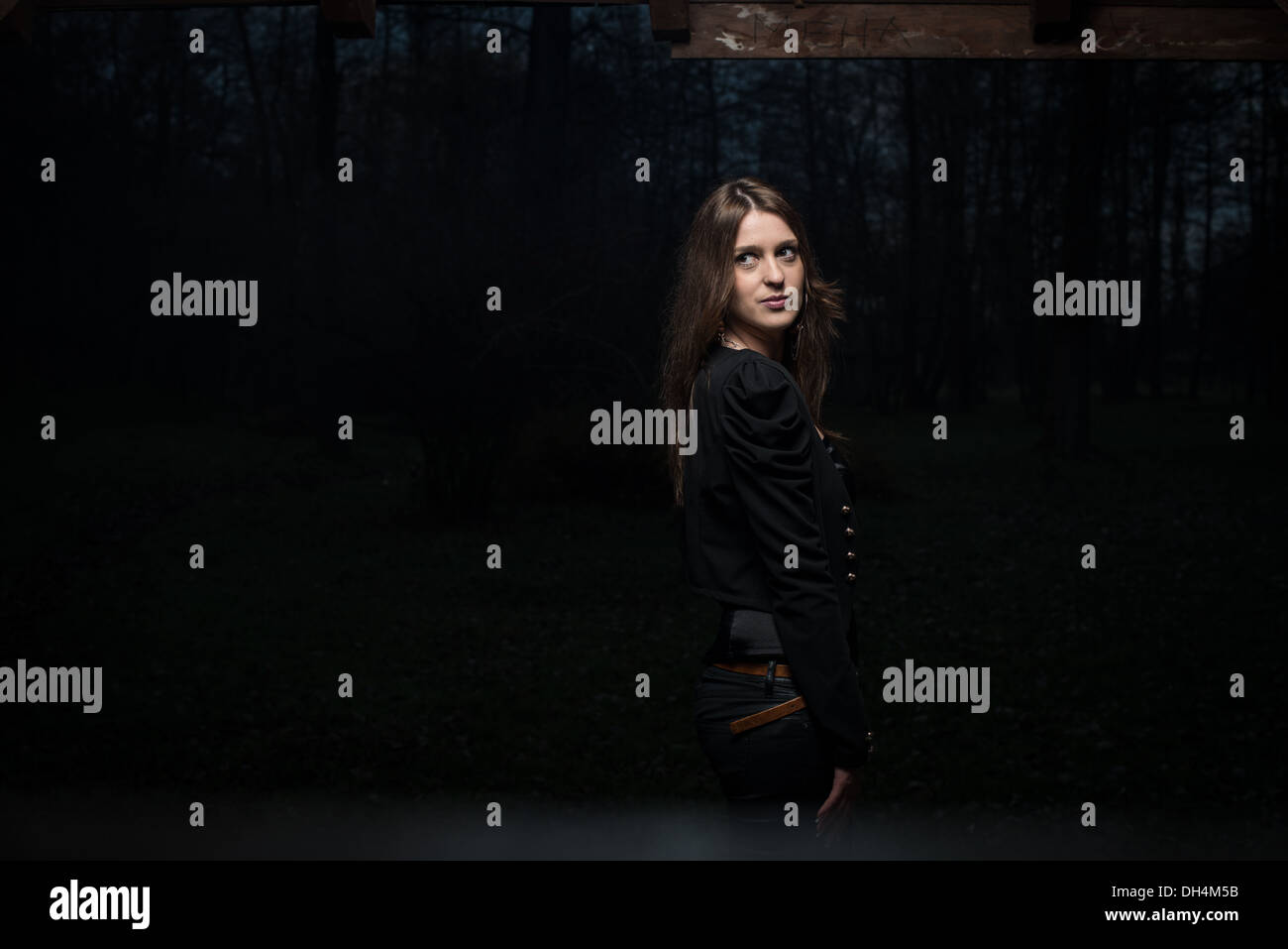 young woman looking behind her shoulder Stock Photo - Alamy