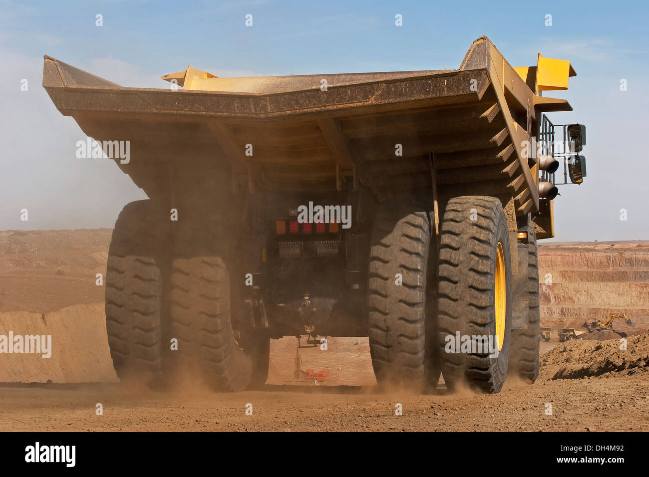 Gold mine operation showing back of large empty haul truck entering ...