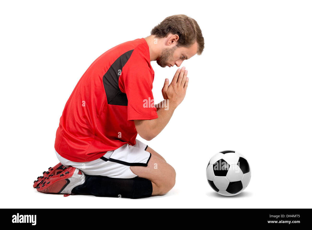 Football player praying isolated in white Stock Photo - Alamy