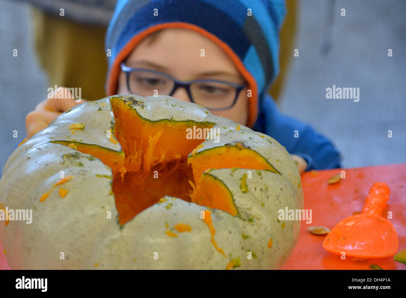Erfurt, Germany. 31st Oct, 2013. Eight year old Julian paints a pumpkin ...