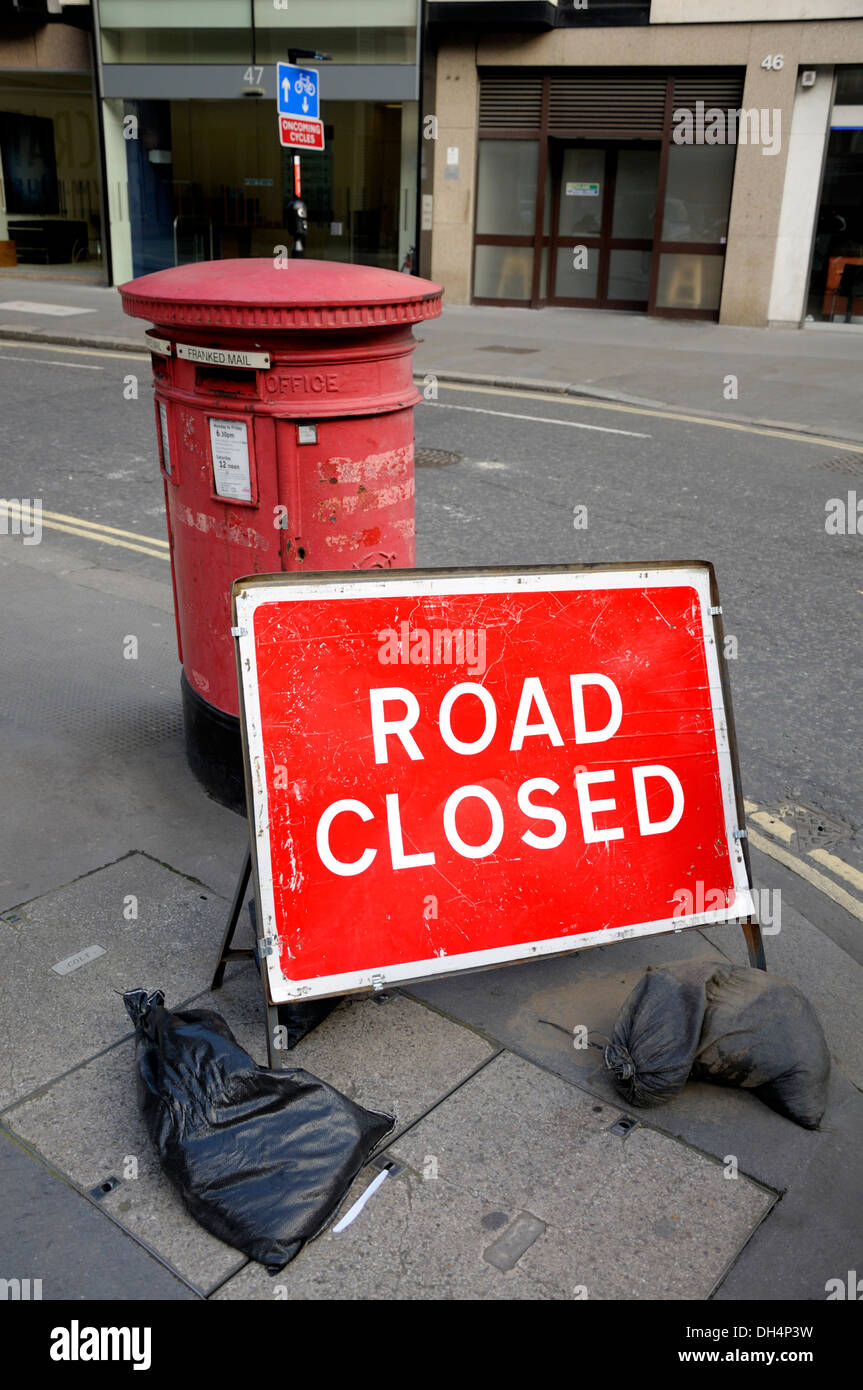 London, England, UK. Red letter box and Road Closed sign in the City ...