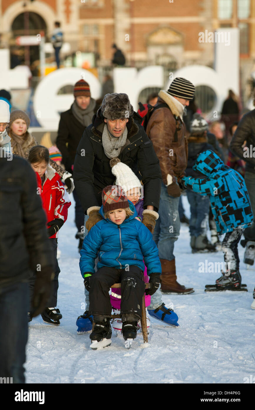 Netherlands, Amsterdam, Children getting used to iceskating on frozen ...