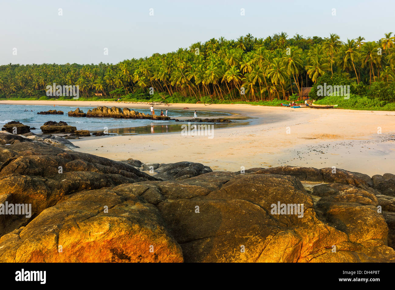 Local residents enjoy a beautiful sunset and low tide along Cherai ...