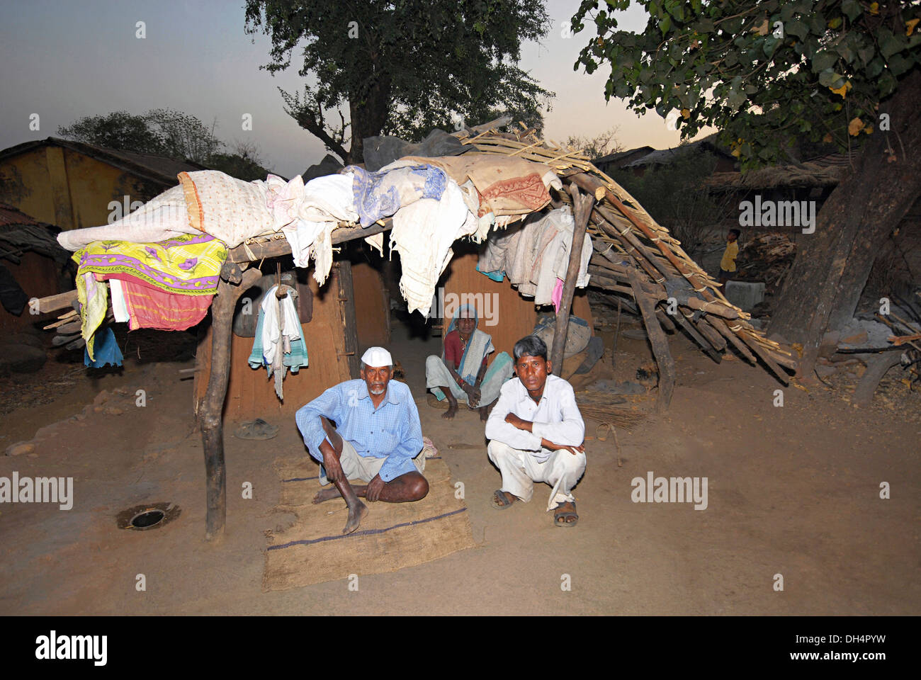 Tribal family sitting outside their hut, Bhil Tribe, Madhya Pradesh ...