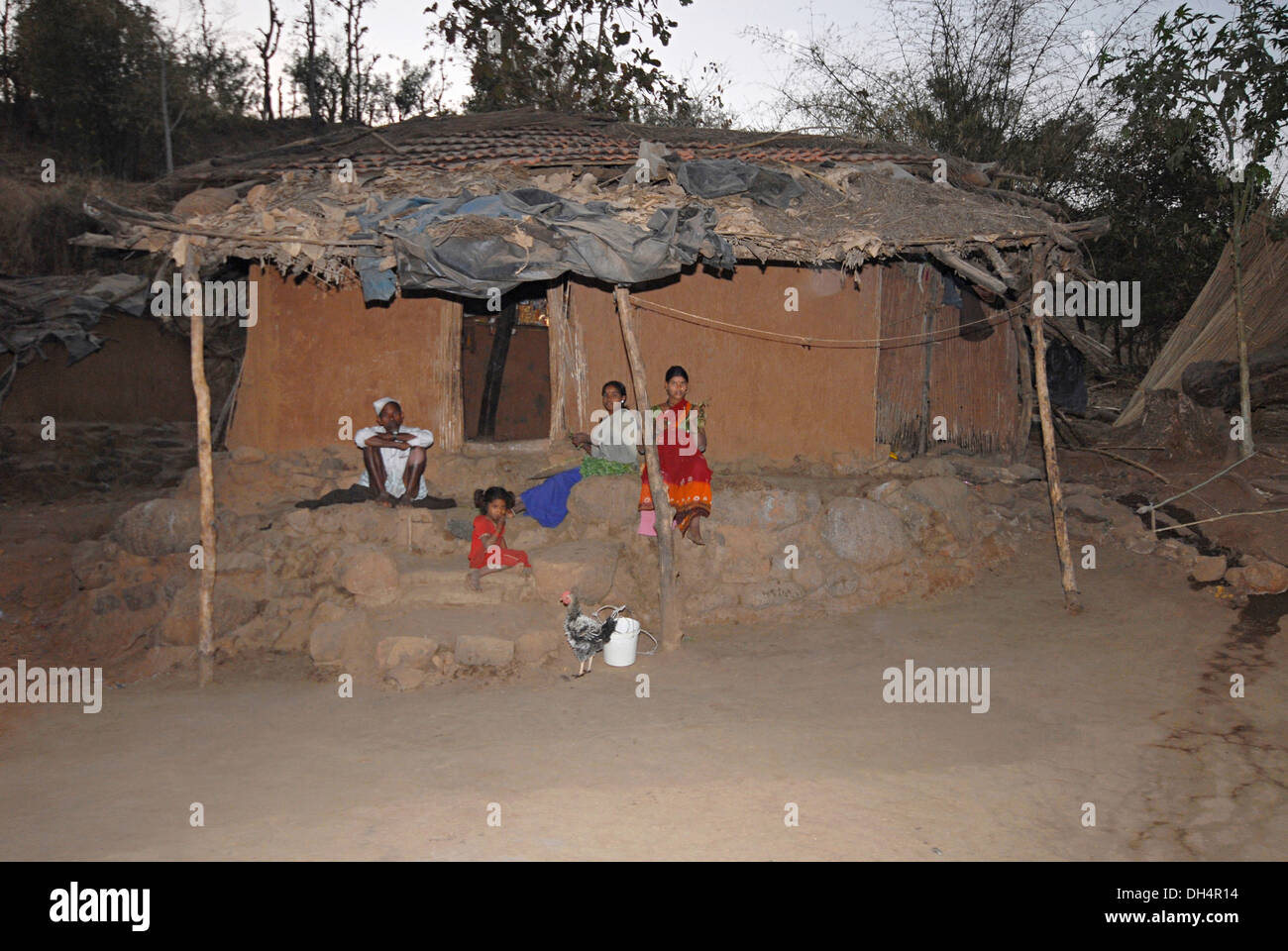 Tribal family sitting outside their hut, Bhil Tribe, Madhya Pradesh ...