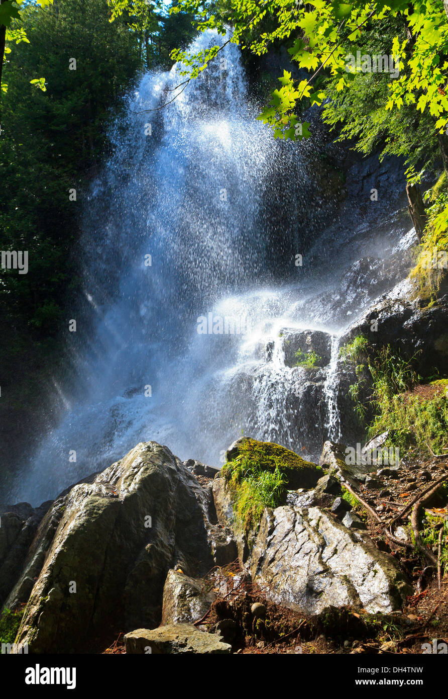 Shafts of sunlight illuminate the spray at Beaver Meadow Falls in the ...