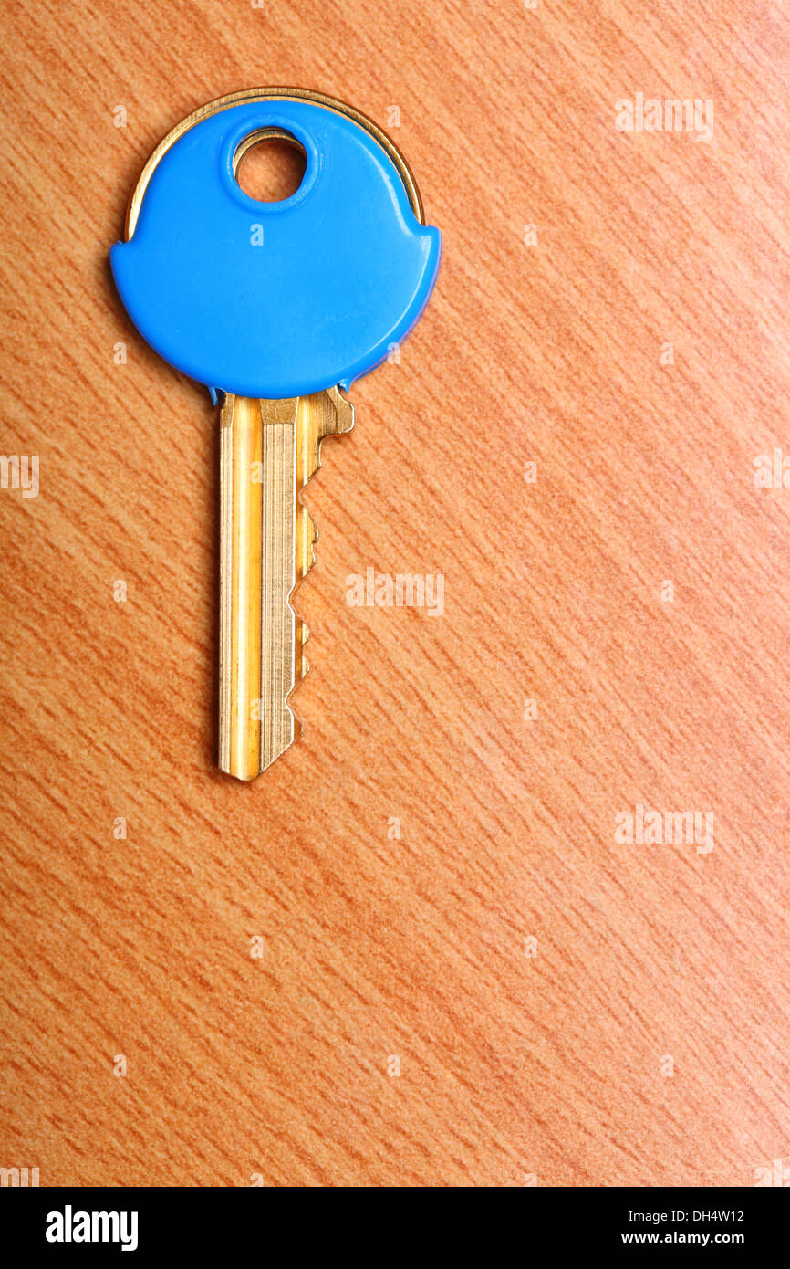 House key with blue plastic coats caps on wooden table background Stock ...