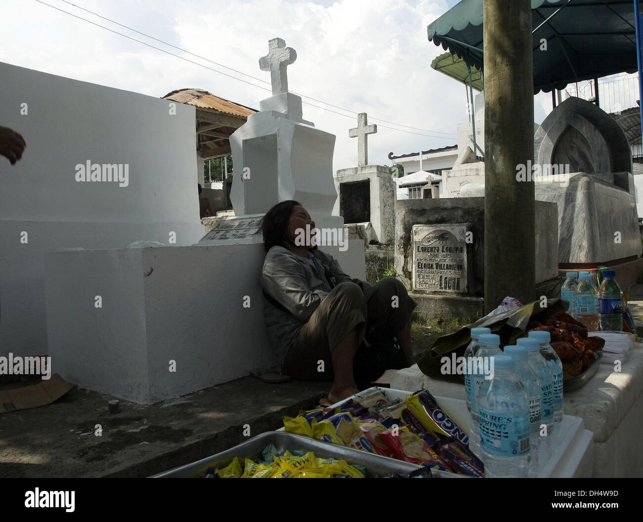 Davao, Philippines. 31st Oct, 2013. Filipino vendor sleeps beside a ...
