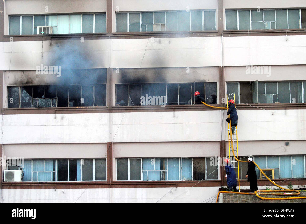 Firefighters busy in extinguish fire on burning building after fire ...