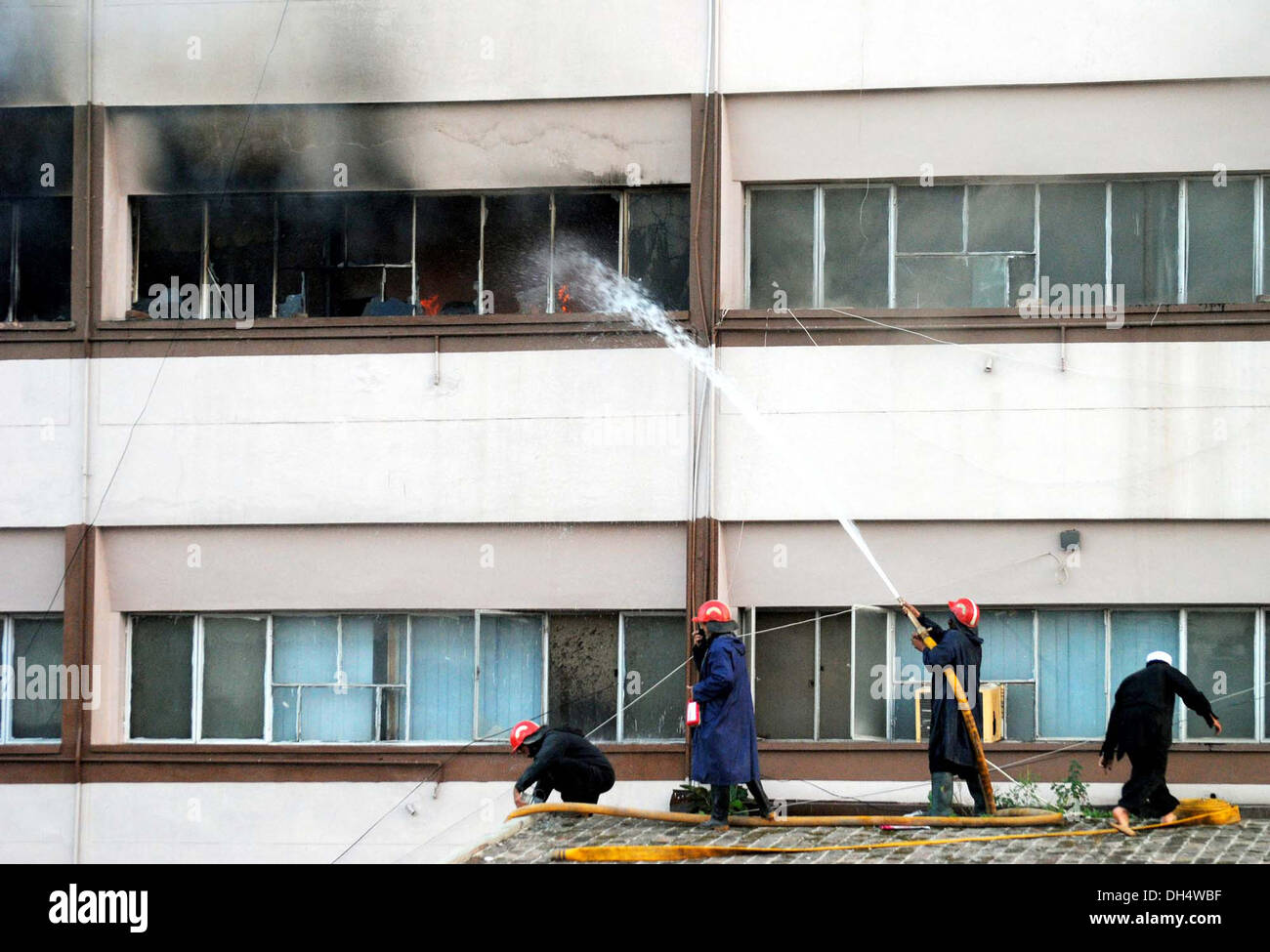Firefighters busy in extinguish fire on burning building after fire ...