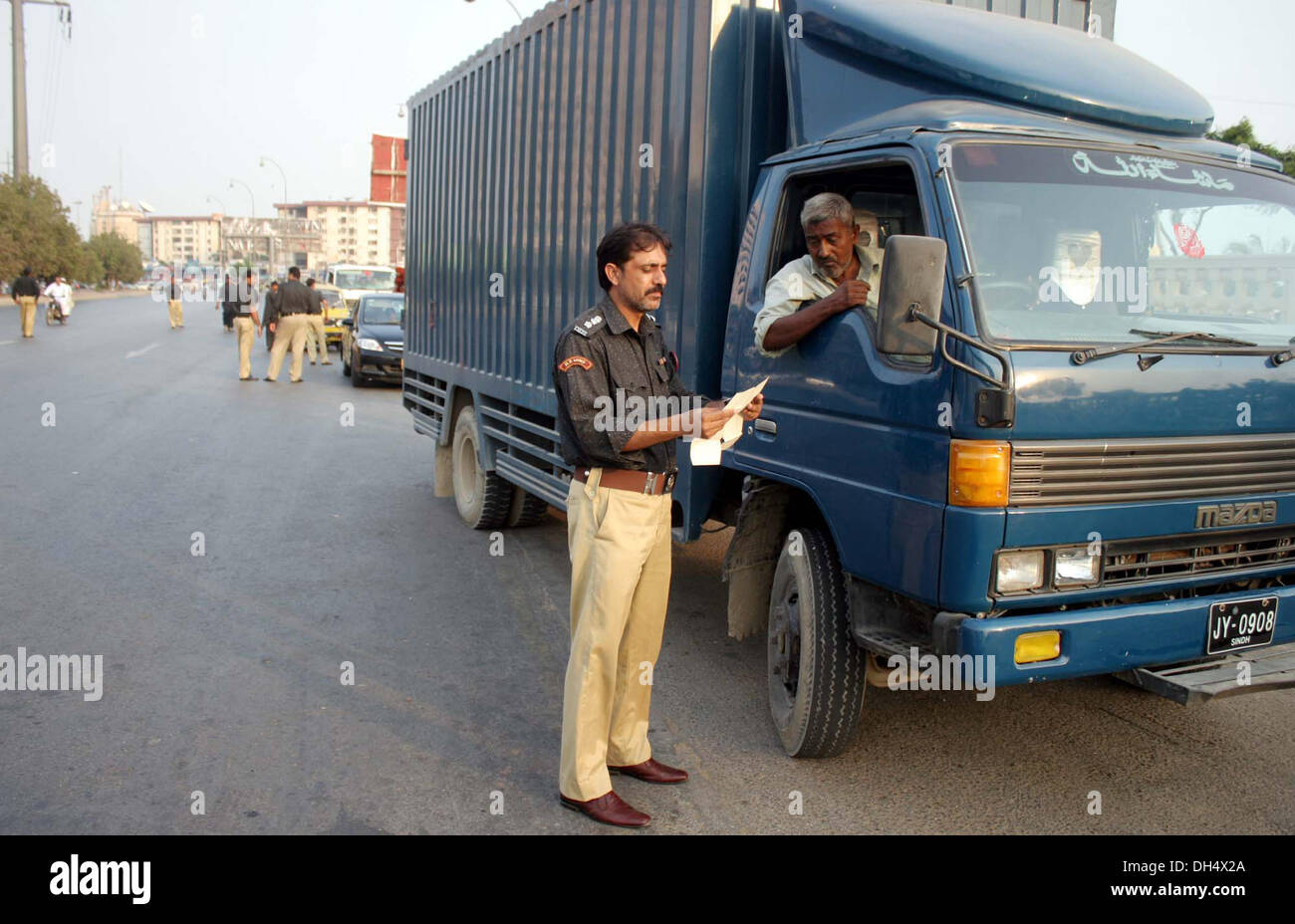 Excise Police officials check vehicle documents during snap checking as ...