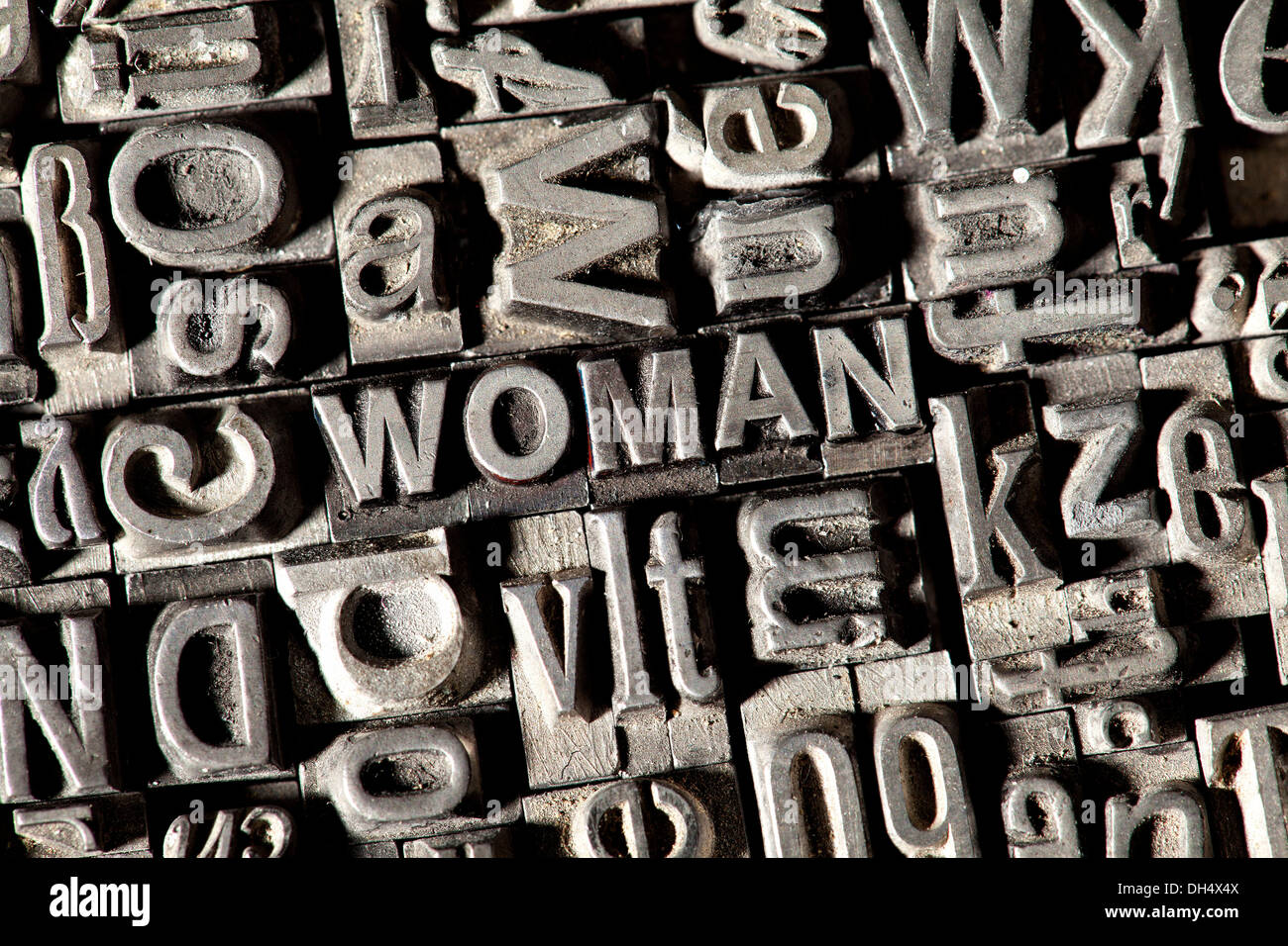 Old lead letters forming the word WOMAN Stock Photo - Alamy