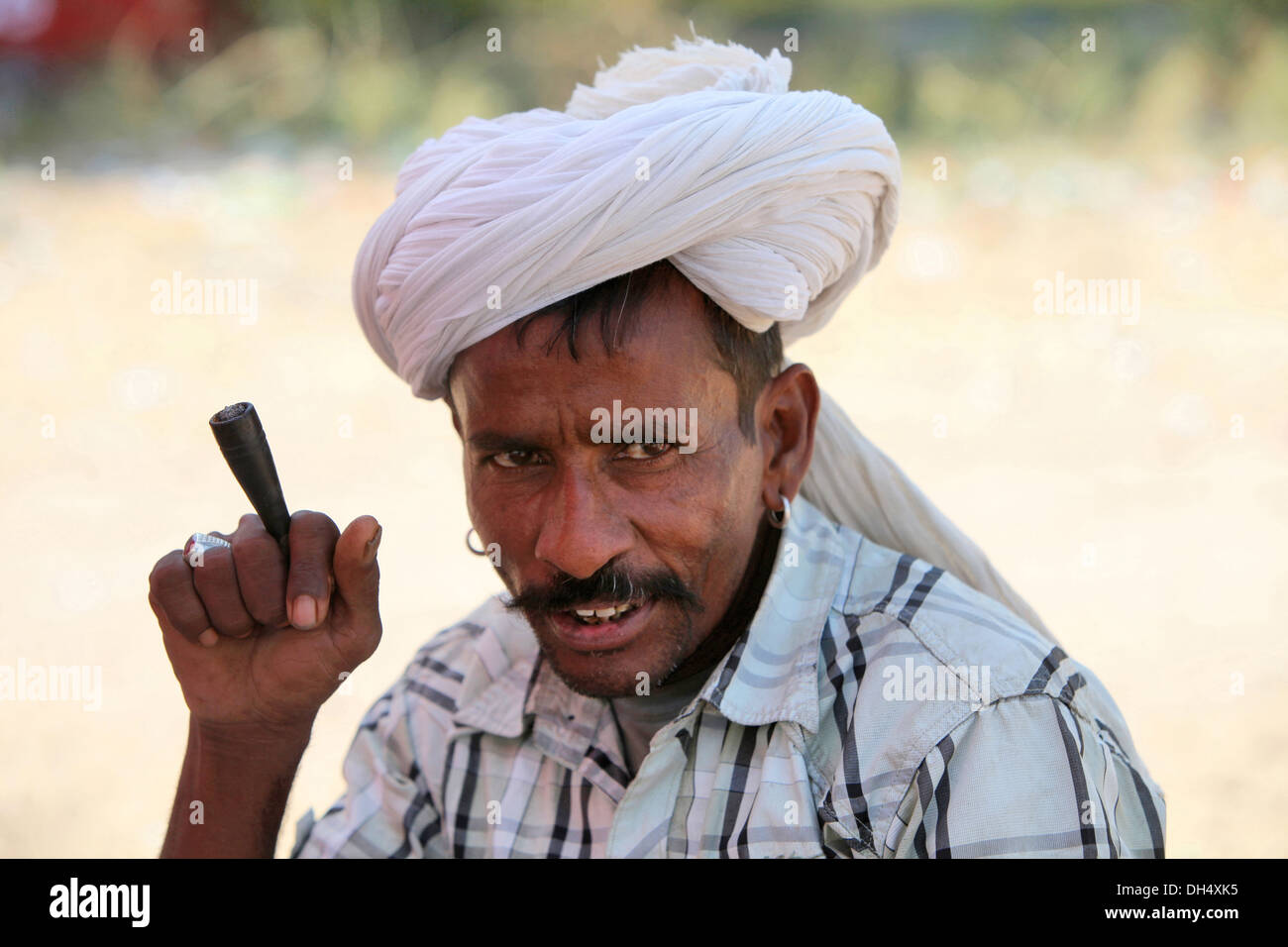 Close-up of an old Bhil tribal man smoking chilim, Madhya Pradesh ...