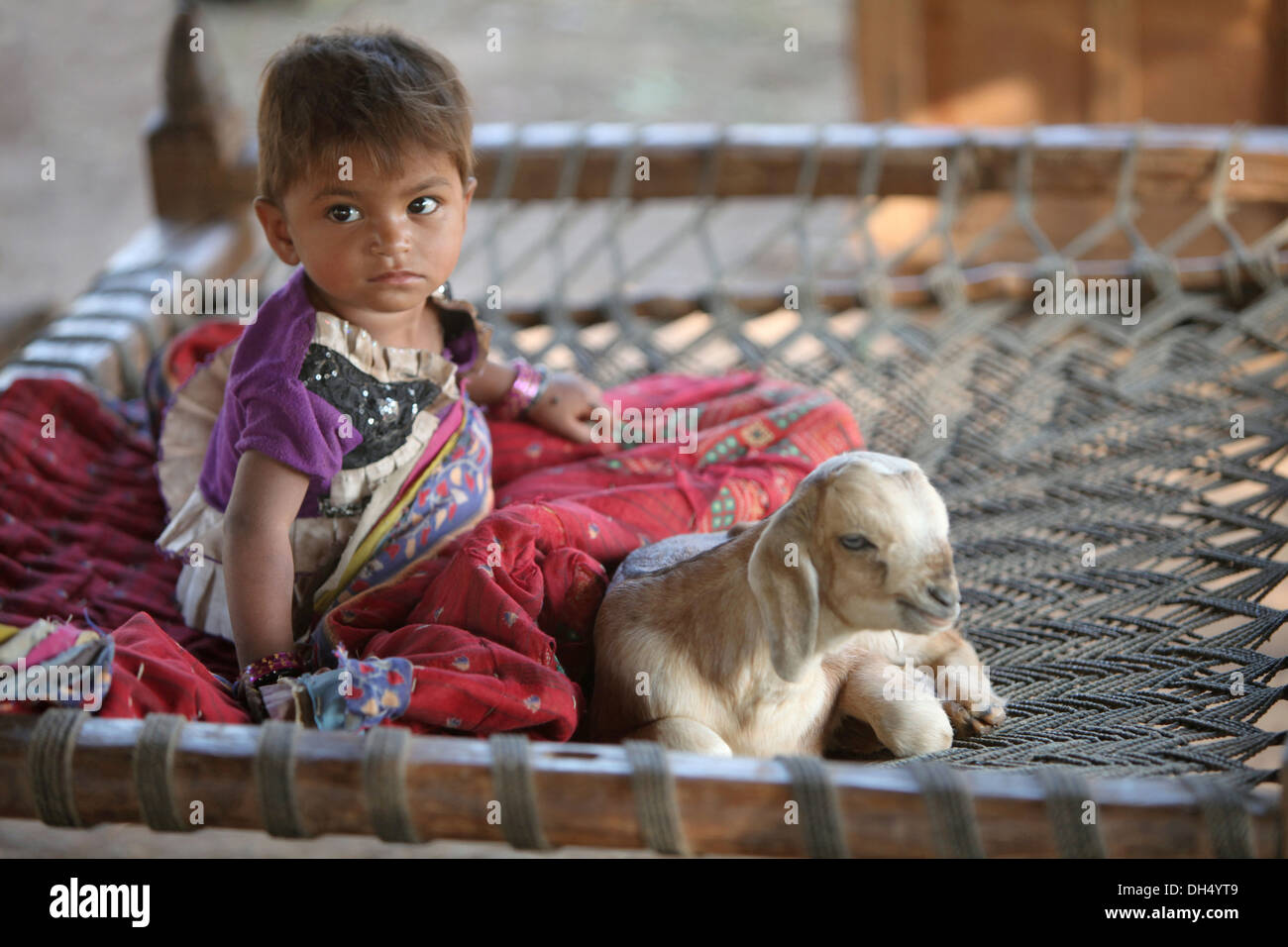 Tribal child with goat kid, Bhil Tribe, Madhya Pradesh, India Stock ...