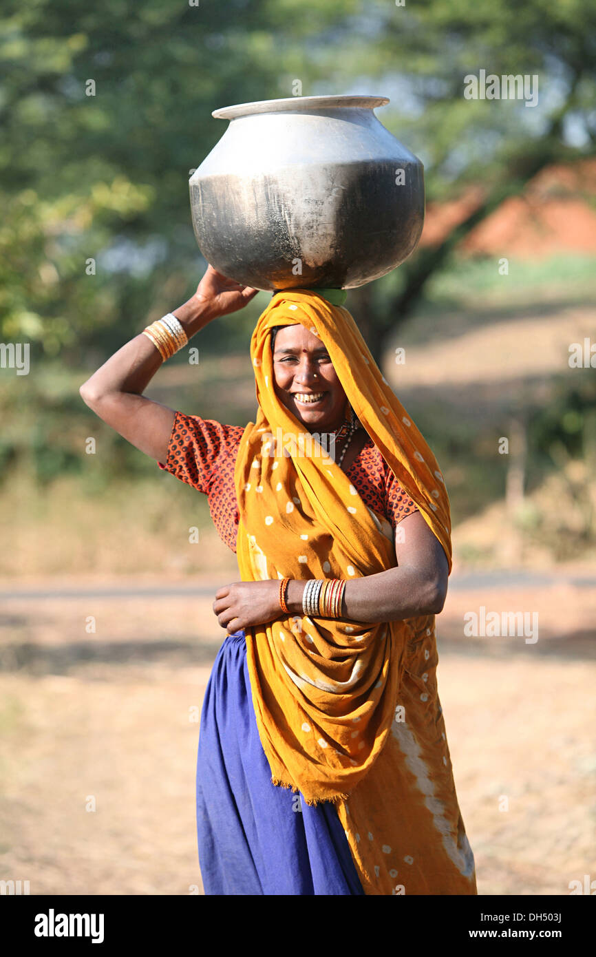 Tribal lady carrying water vessel on her head, Madhya Pradesh, India ...
