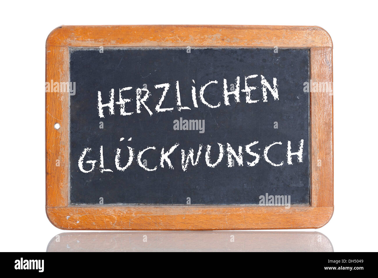 Old chalkboard, lettering "HERZLICHEN GLUECKWUNSCH", German for ...