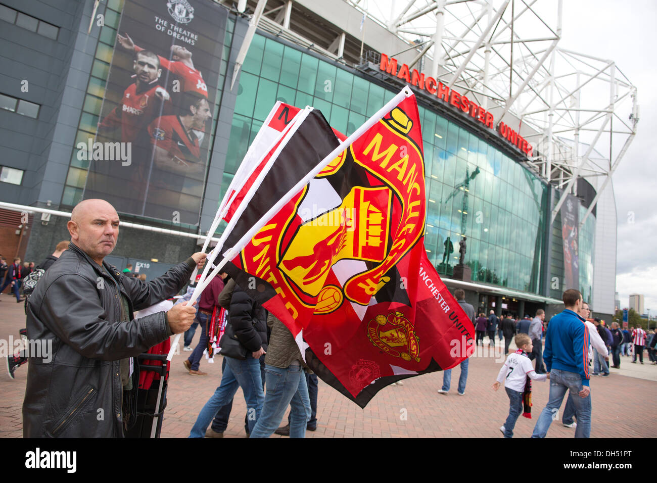 Man selling merchandise outside Old Trafford Football Stadium, in ...