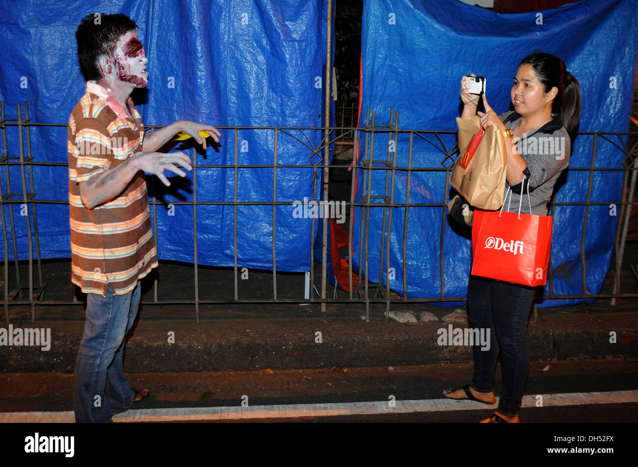 Manila, Philippines. 31st Oct, 2013. A woman takes a photo of a ...