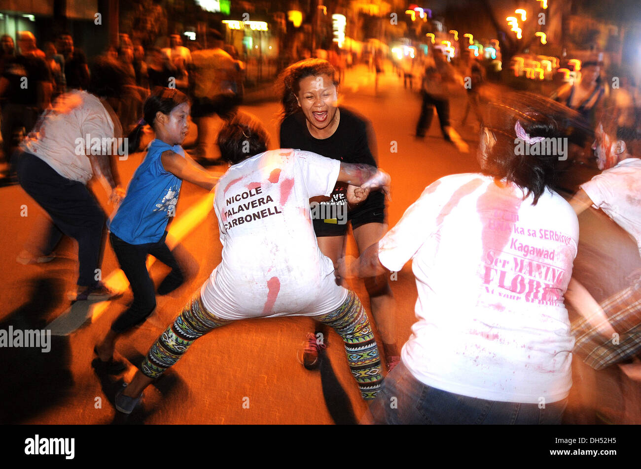 Manila, Philippines. 31st Oct, 2013. A runner screams as she is ...