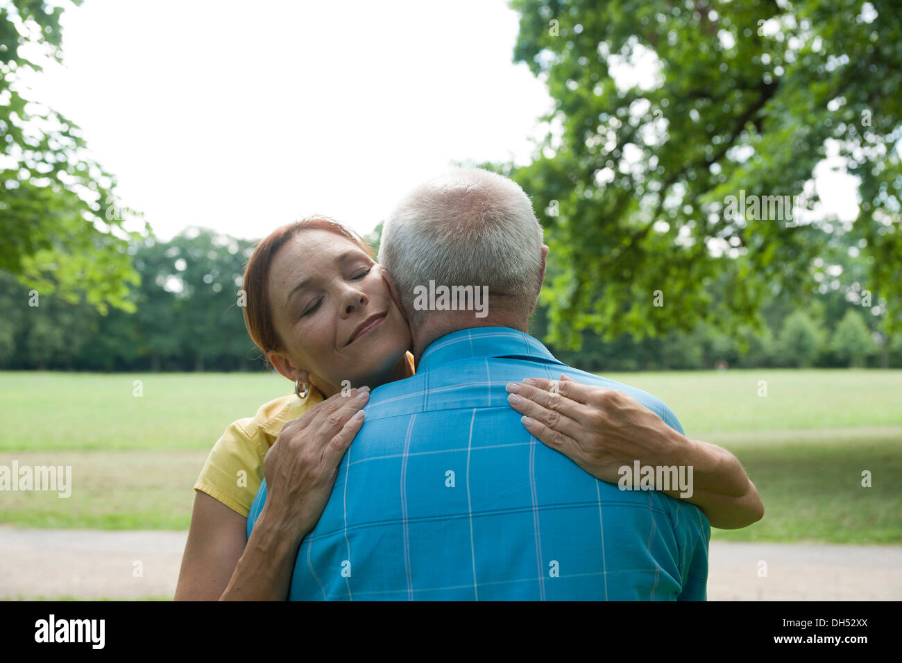 Woman hugging an elderly man Stock Photo - Alamy