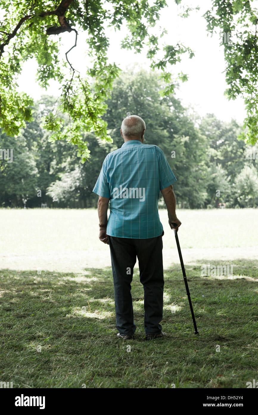 Elderly man with a walking cane in a park Stock Photo - Alamy