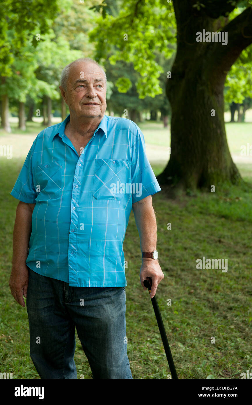 Old man walking alone in a park hi-res stock photography and images - Alamy