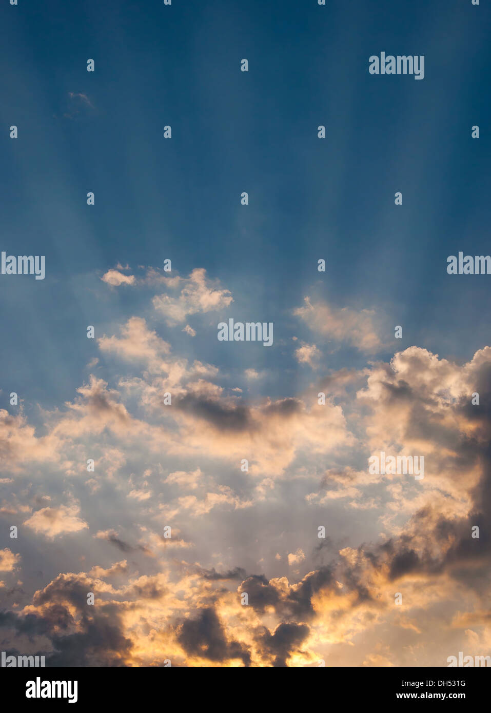 Suns rays beaming from behind clouds Stock Photo - Alamy