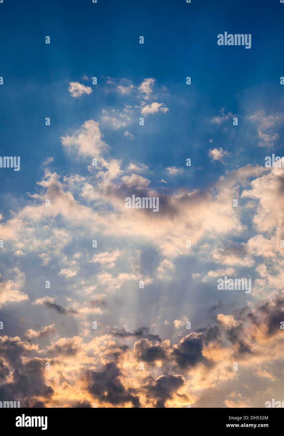 Suns rays beaming from behind clouds Stock Photo - Alamy