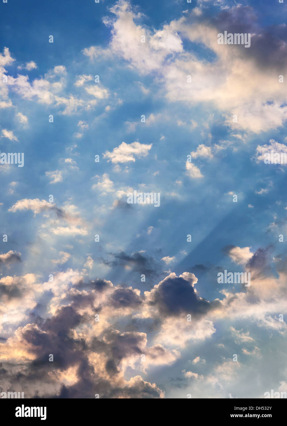 Suns rays beaming from behind clouds Stock Photo - Alamy