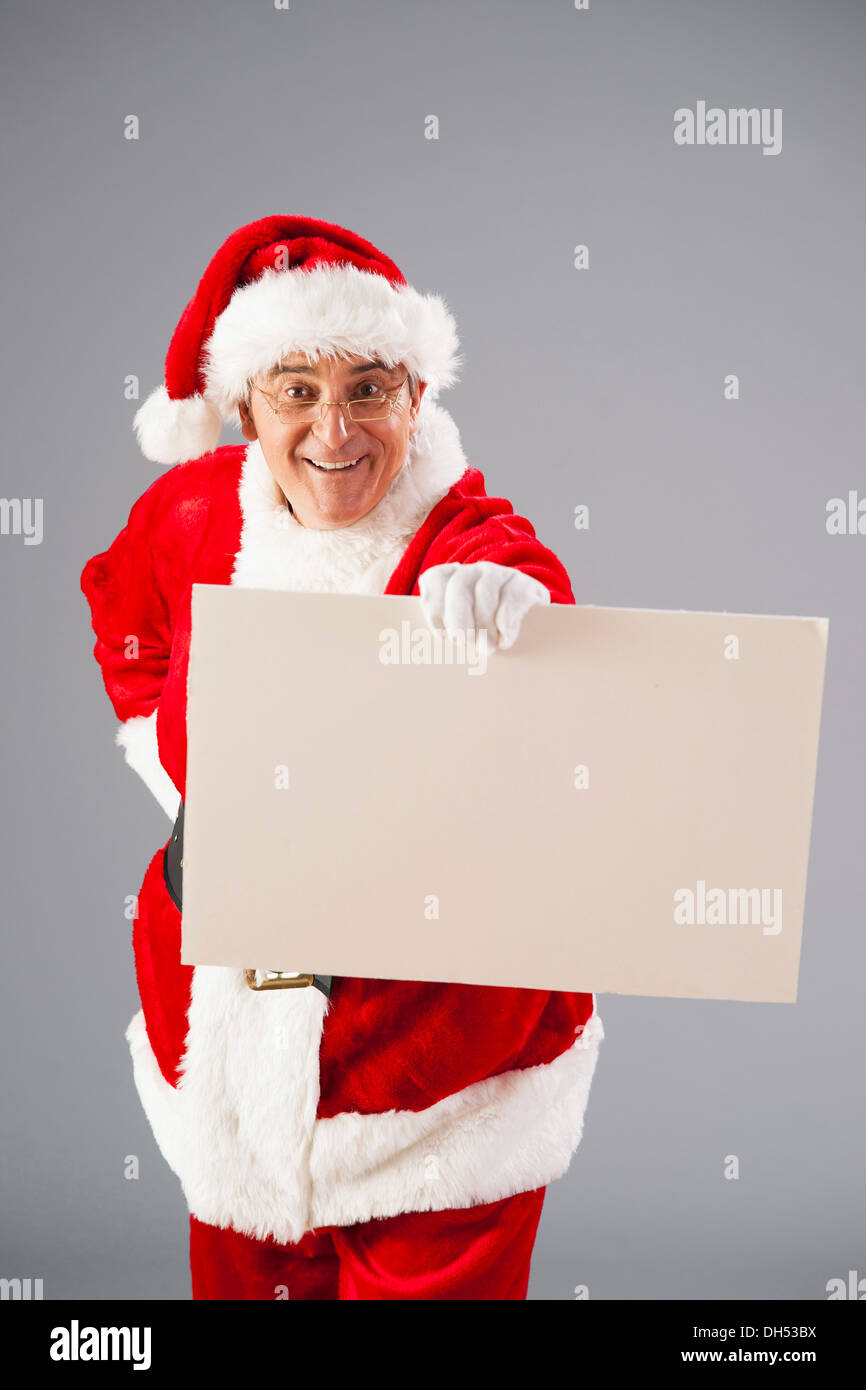 Santa Claus presenting a blank slate Stock Photo - Alamy
