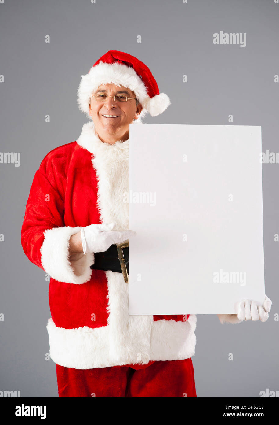 Santa Claus presenting a blank slate Stock Photo - Alamy