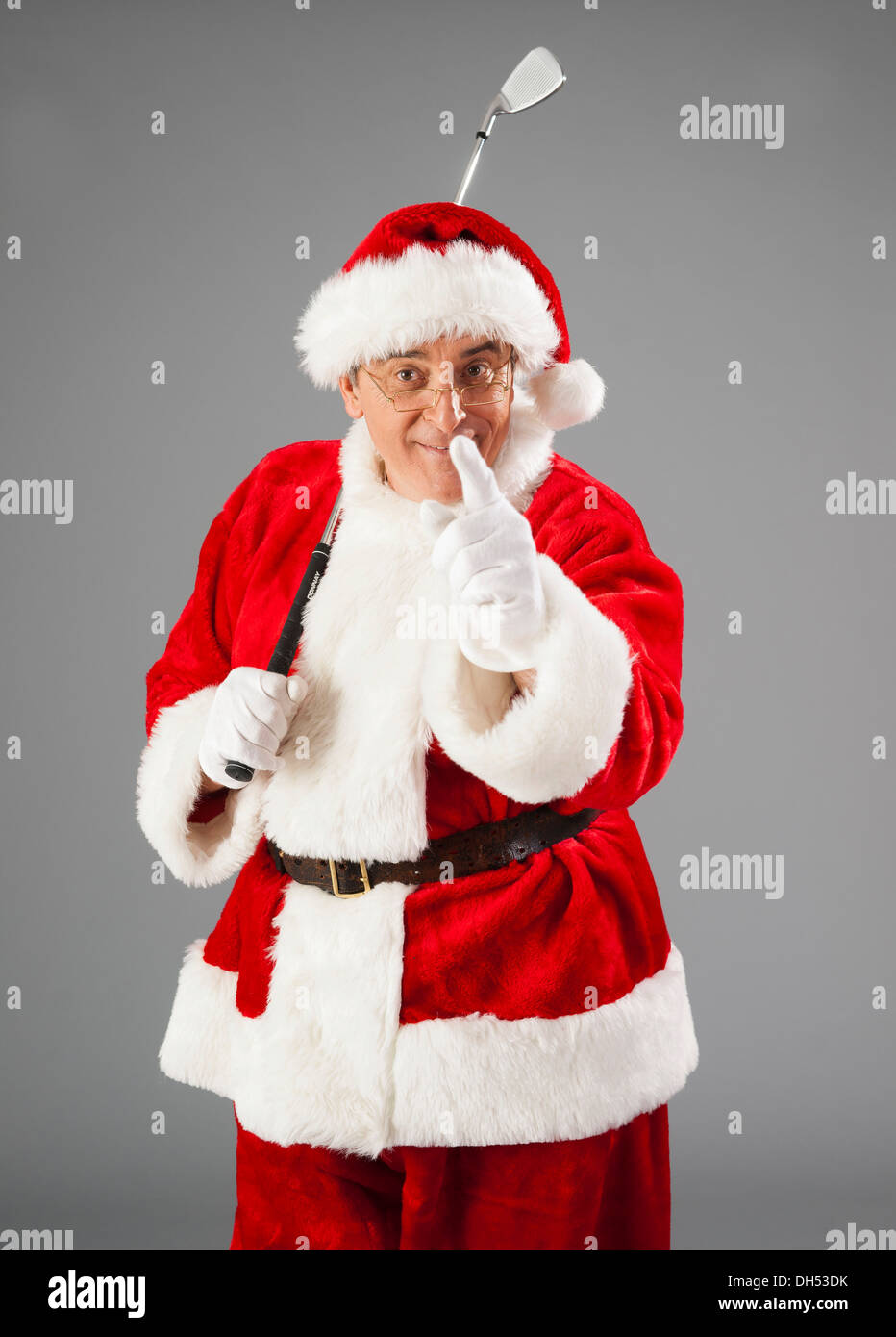 Santa Claus holding a golf club Stock Photo - Alamy