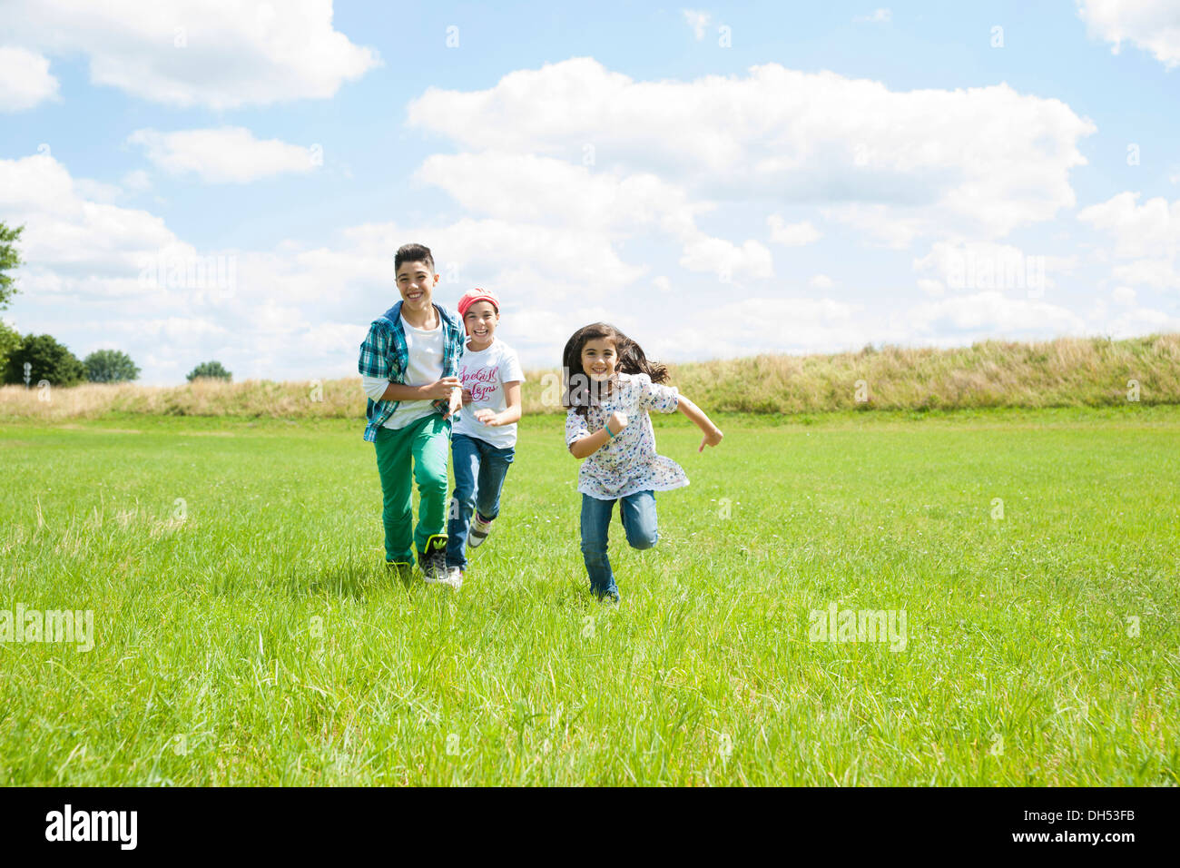 Children racing each other on a meadow Stock Photo - Alamy