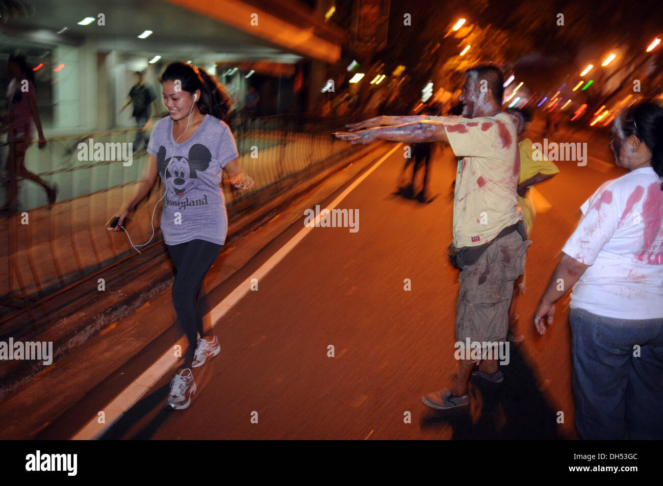 Manila, Philippines. 31st Oct, 2013. A Filipino 'zombie' goes after a ...