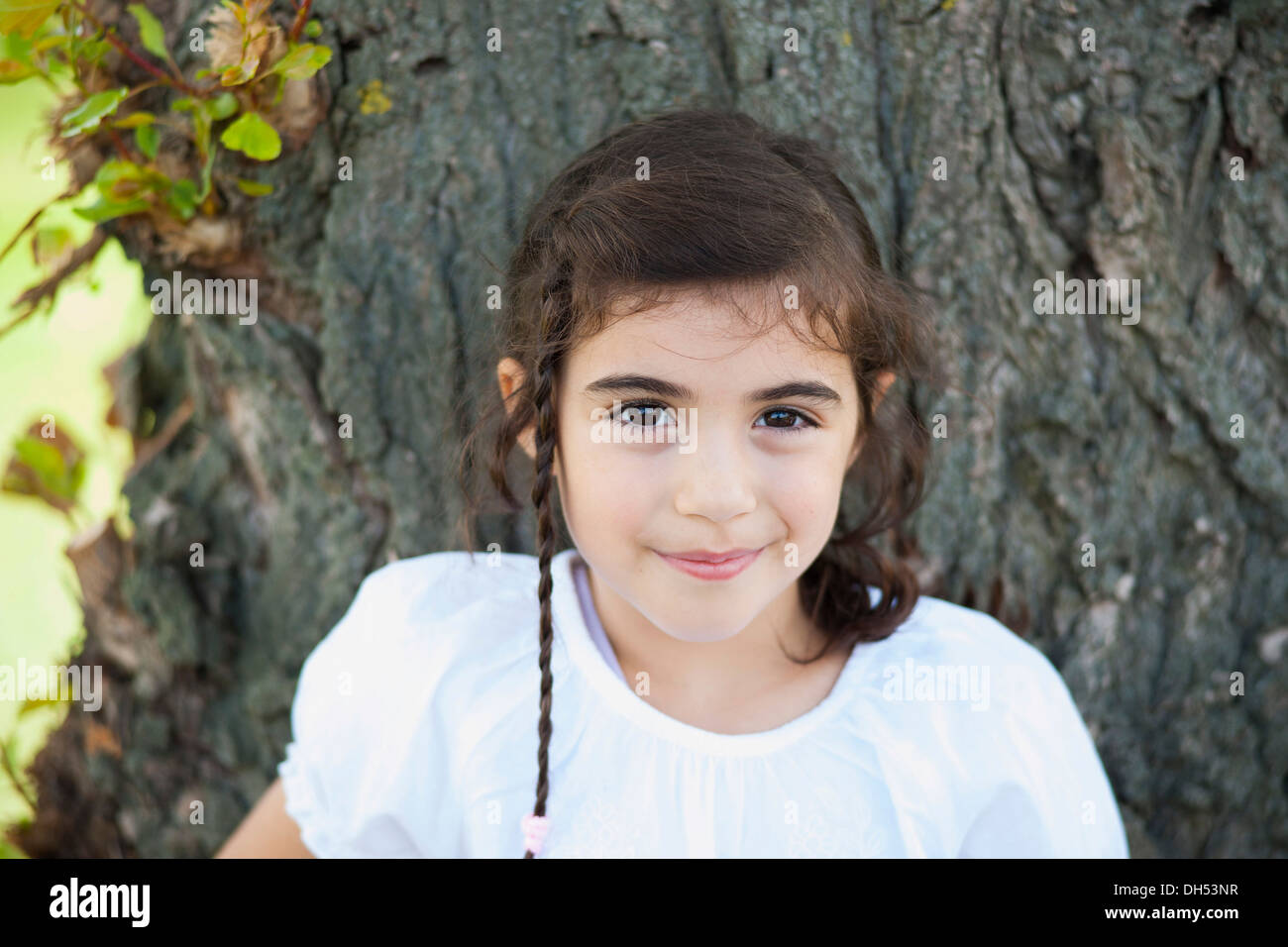 Girl at a tree, portrait Stock Photo - Alamy